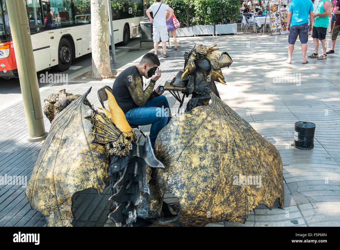 Human statue street entertainer putting on face paint, along La Rambla ...