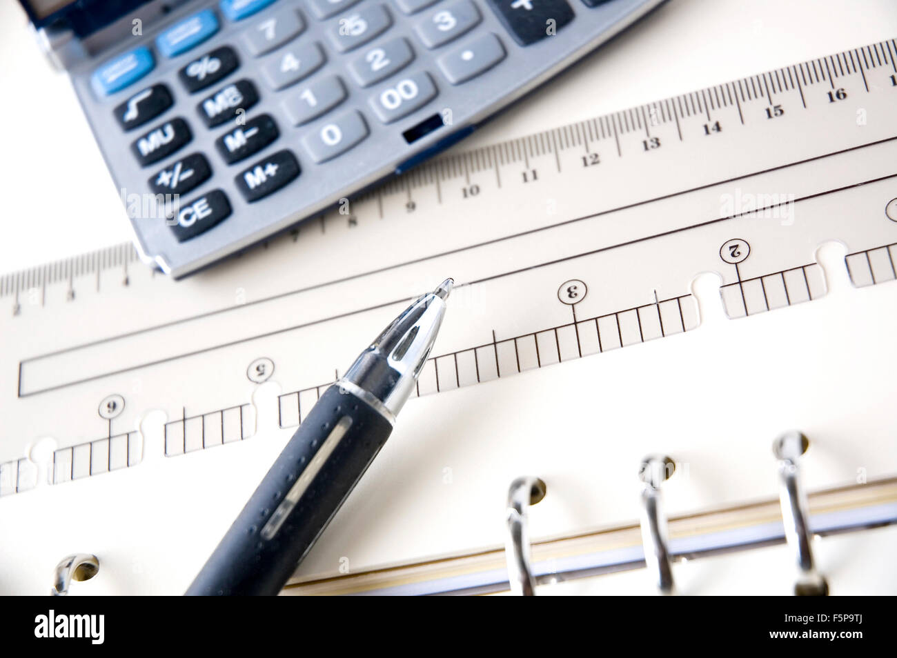 close up pen on scale with calculator Stock Photo - Alamy