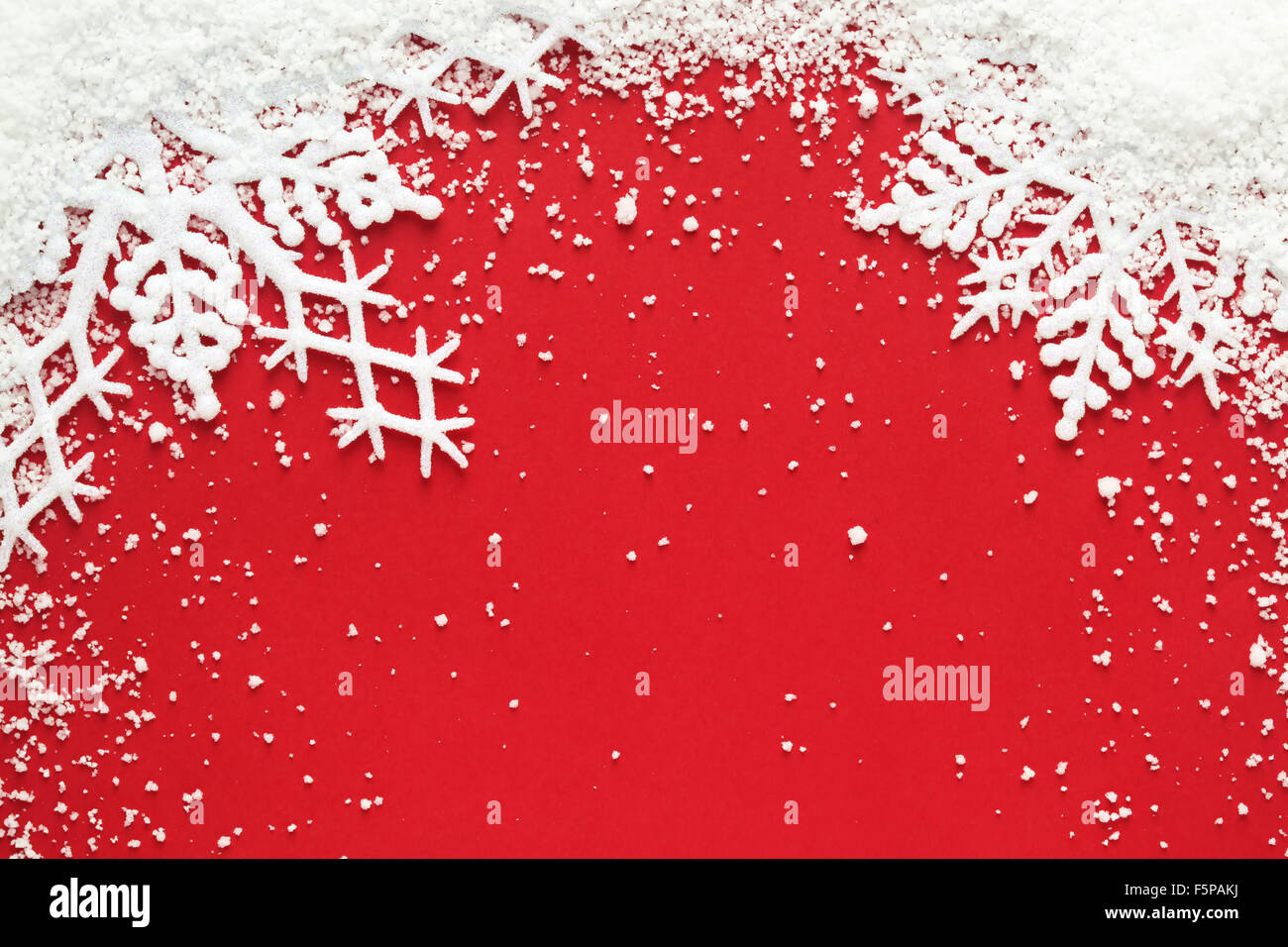 Snowflake and snow on red background Stock Photo - Alamy