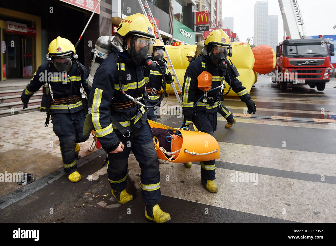 Zhengzhou, China's Henan Province. 8th Nov, 2015. Firefighters rescue ...