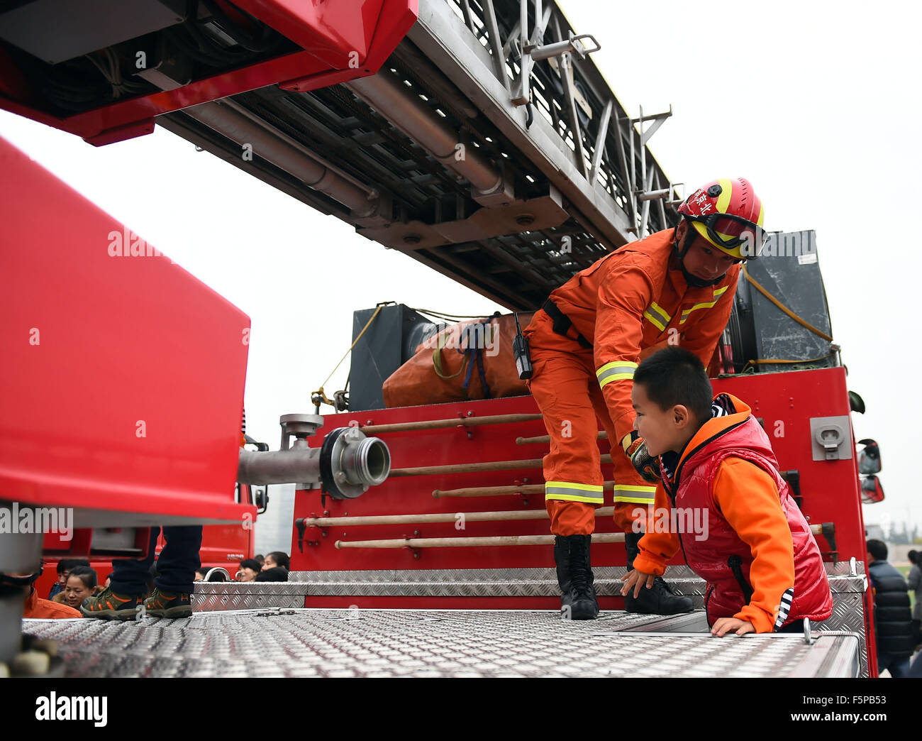 Beijing, China. 8th Nov, 2015. A child gets on a firefighting vehicle ...
