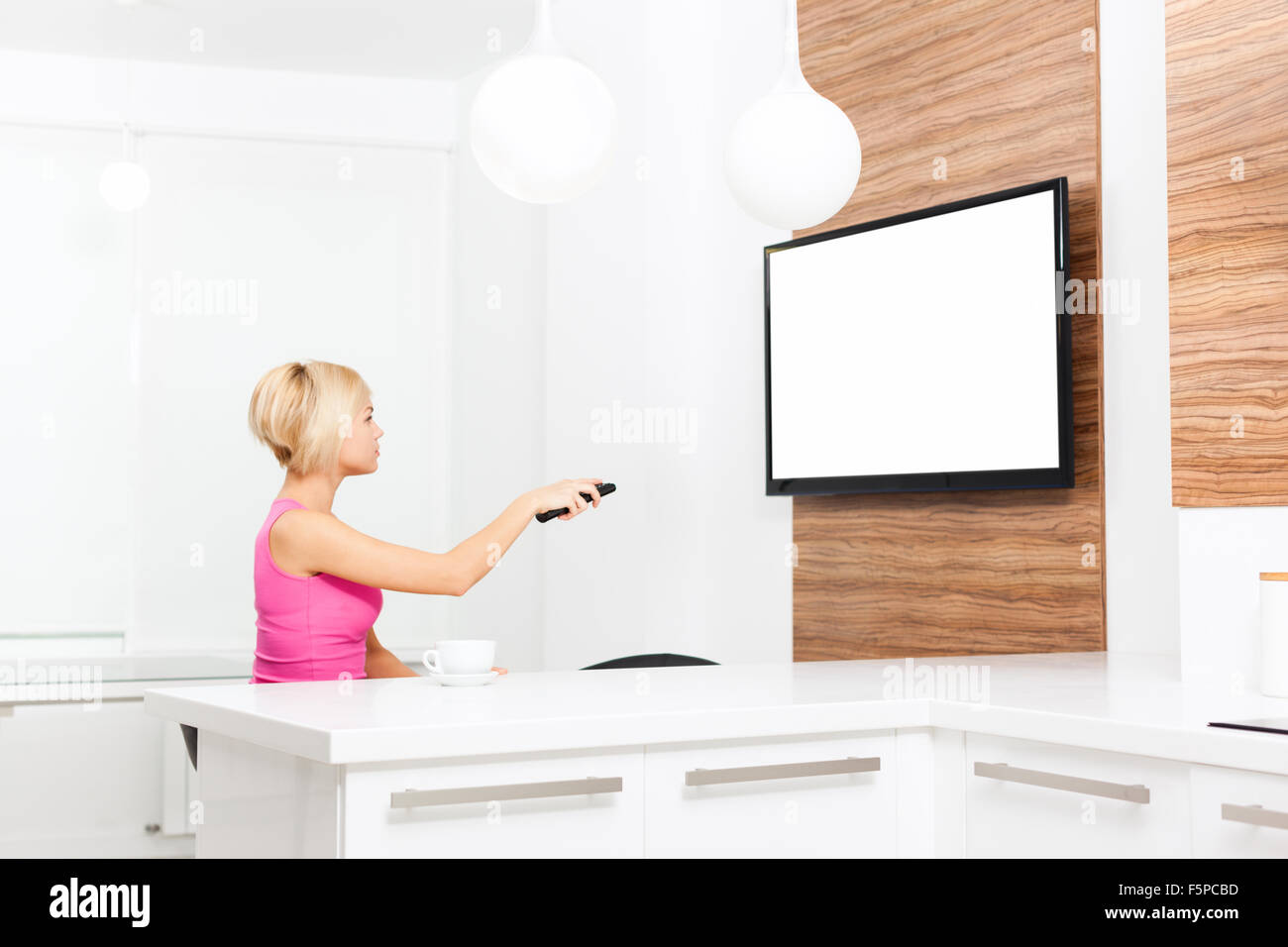 woman watching tv hold remote control Stock Photo - Alamy
