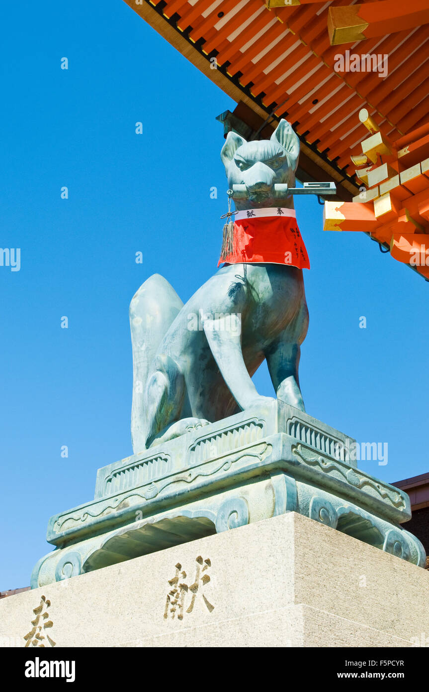 A fox, kitsune, guarding the entrance to Fushimi Inari Taisha Shrine in ...