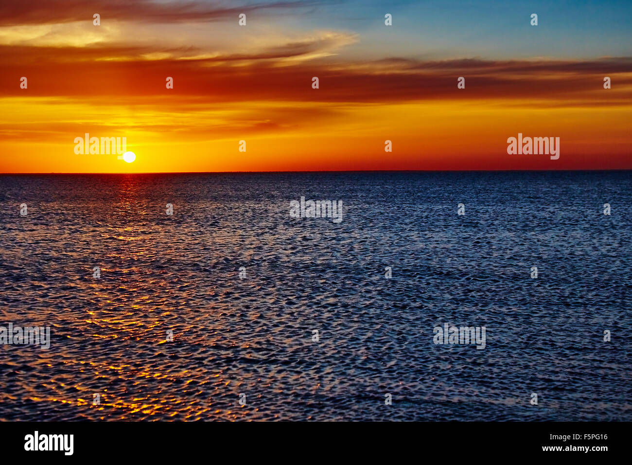 Sunset over the ocean Stock Photo - Alamy