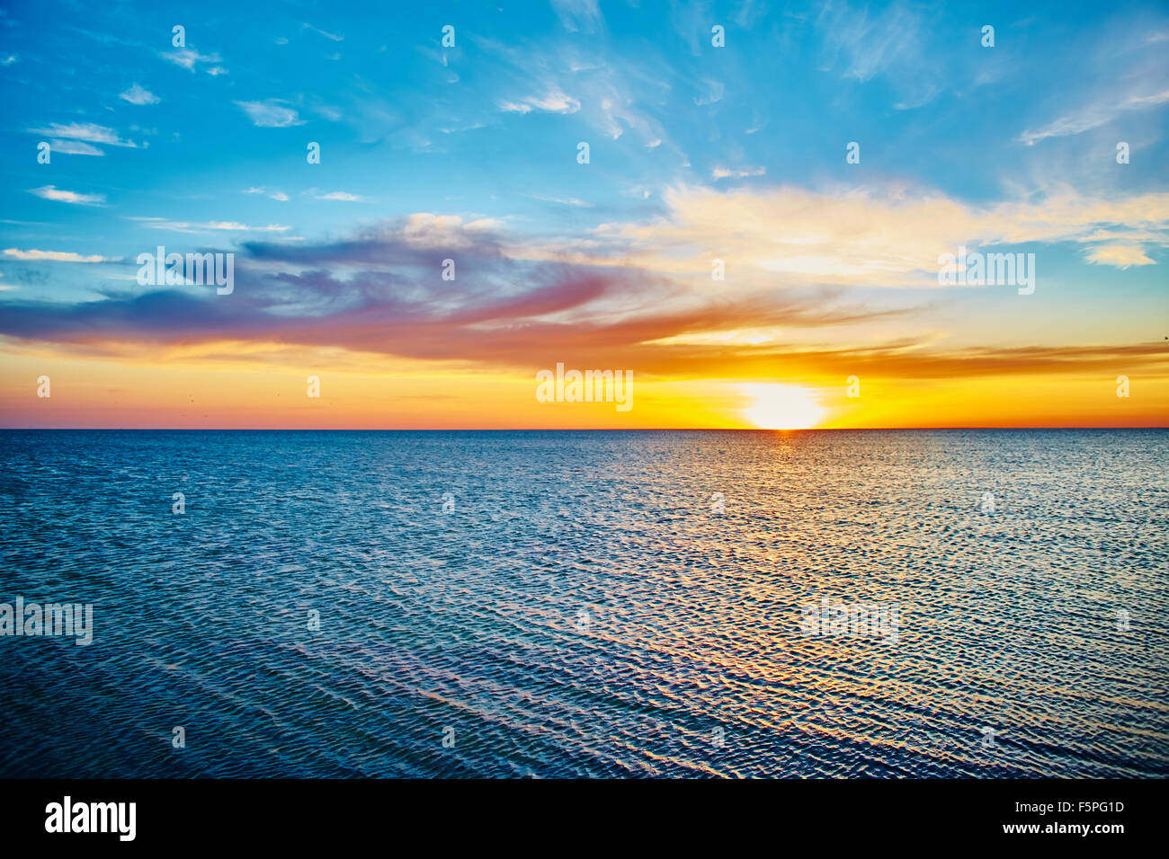 Sunset over the ocean Stock Photo - Alamy