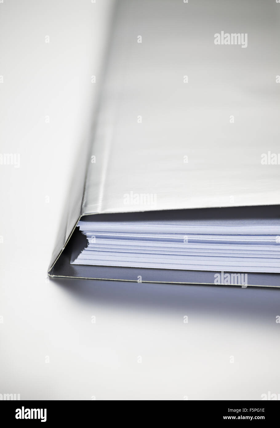 A file full of paper on a white background Stock Photo - Alamy