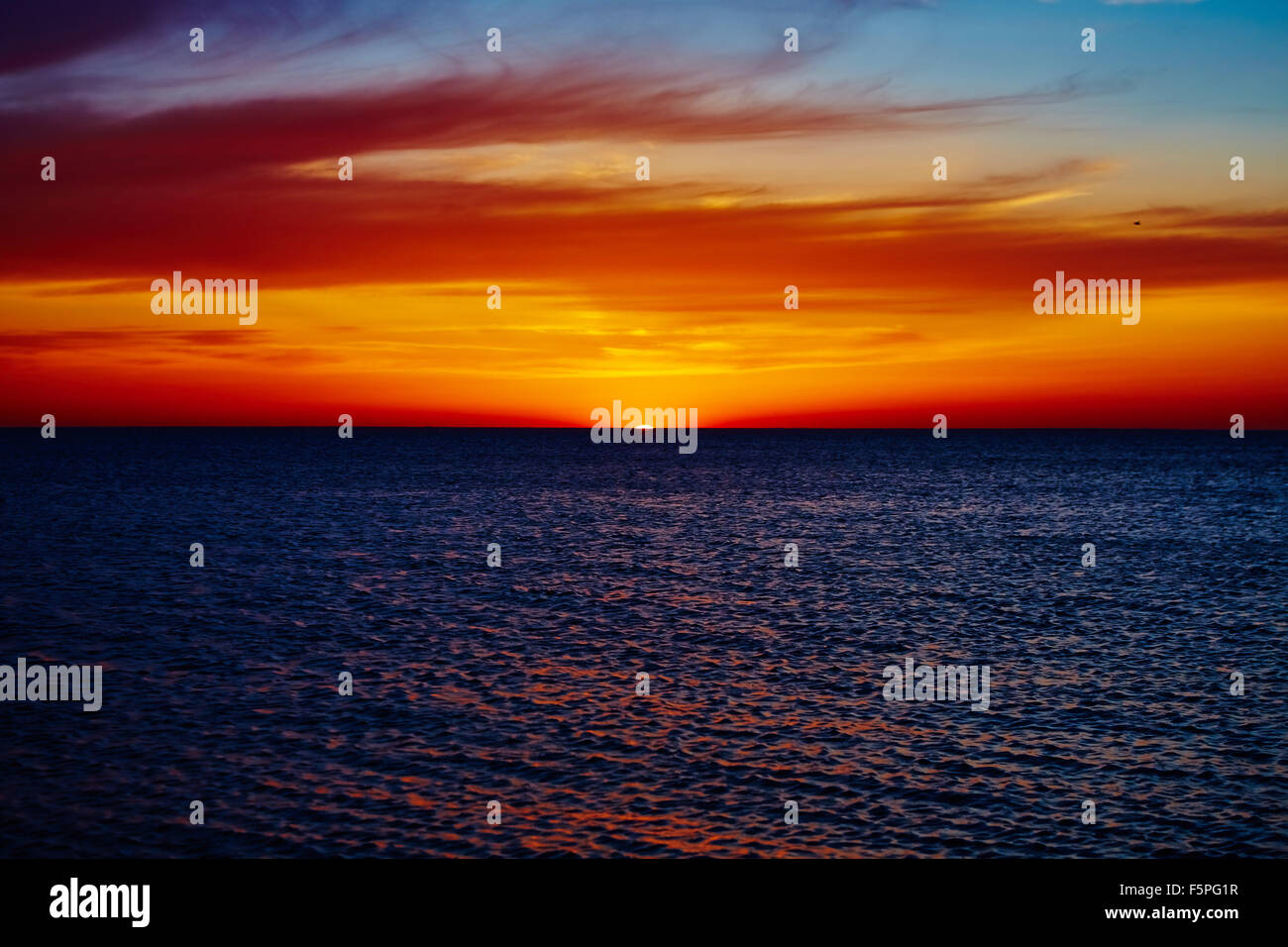 Sunset over the ocean Stock Photo - Alamy