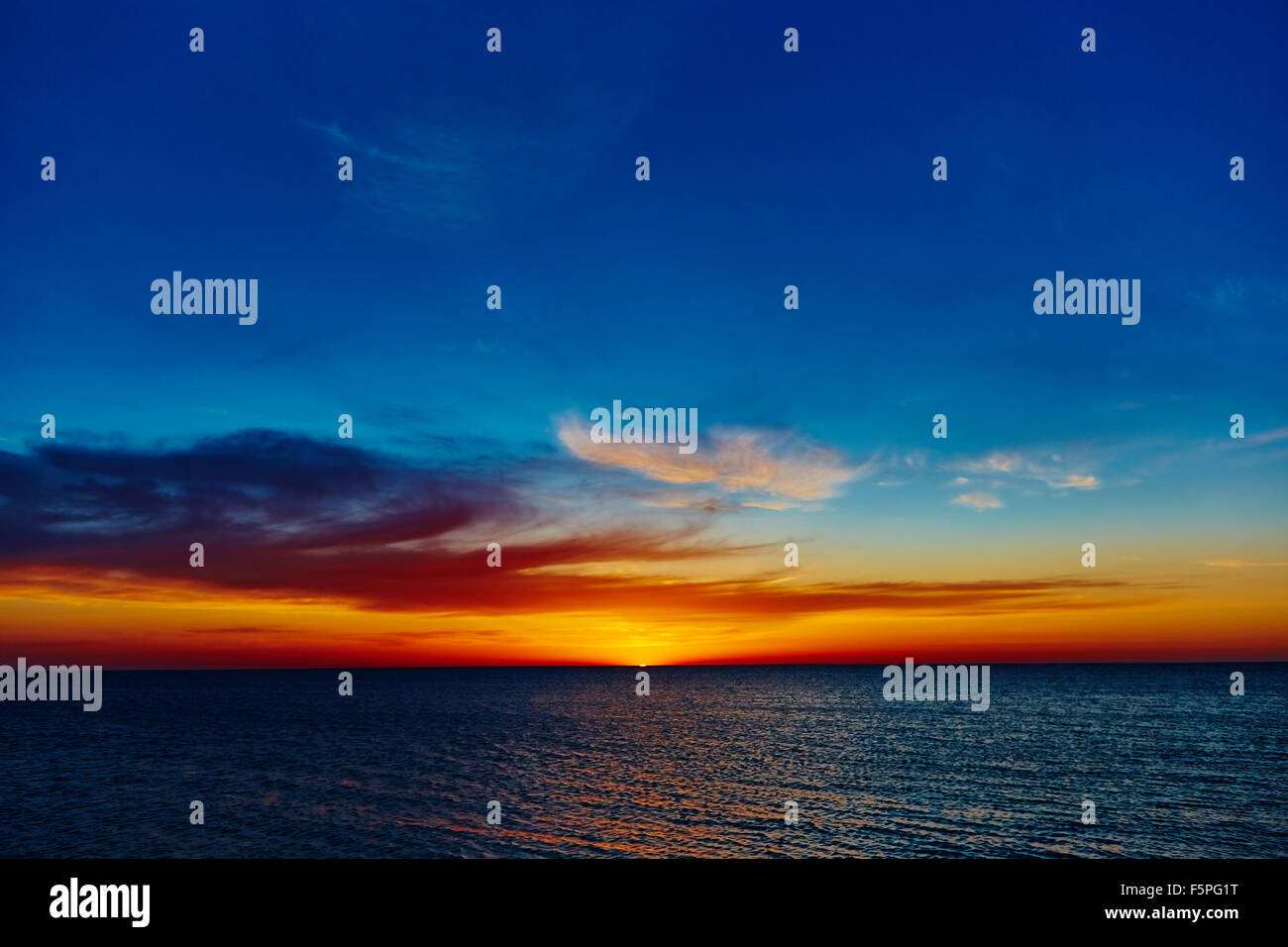 Sunset over the ocean Stock Photo - Alamy