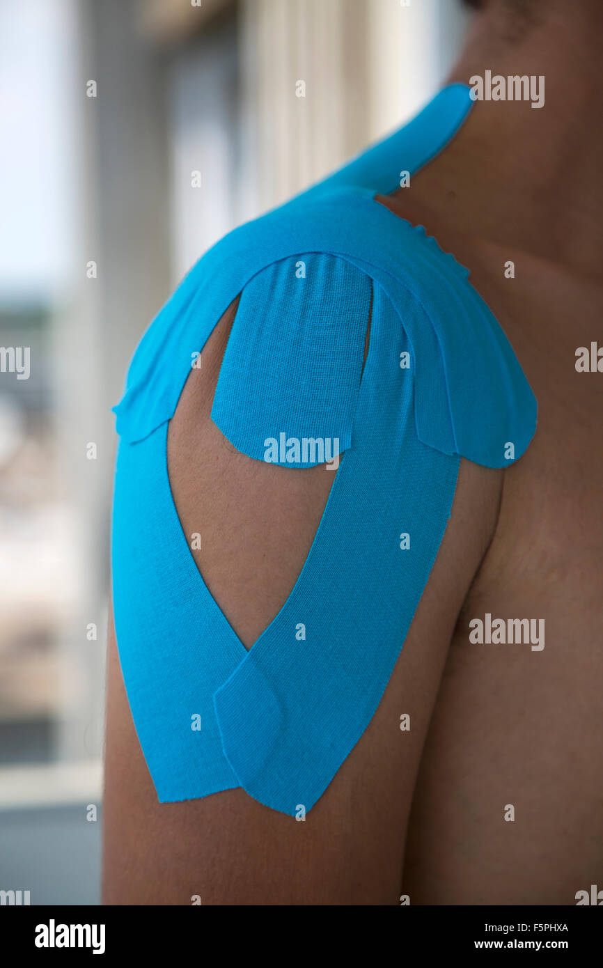 Adhesive bandage on shoulder Stock Photo - Alamy