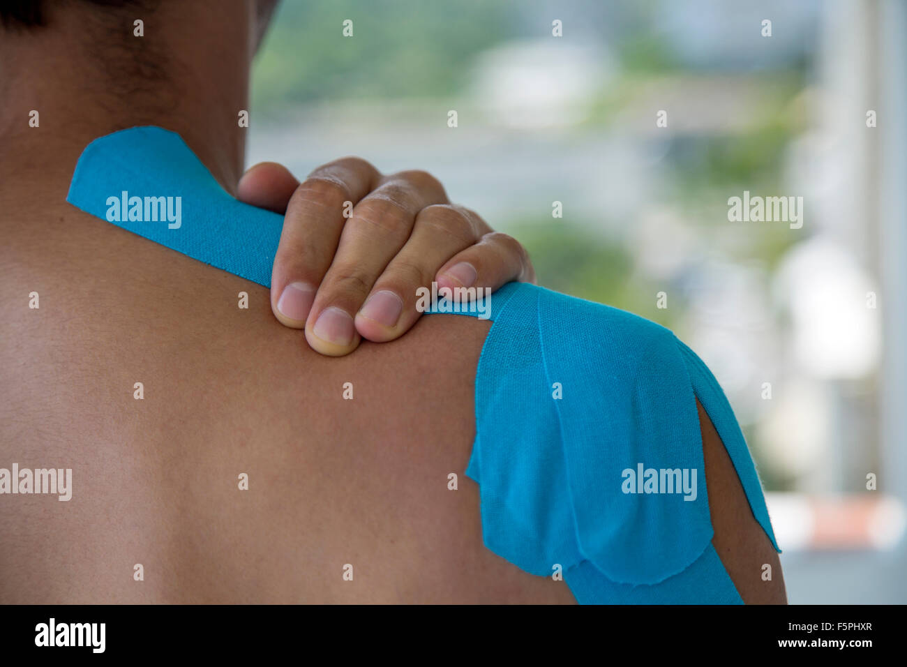 Adhesive bandage on shoulder Stock Photo - Alamy