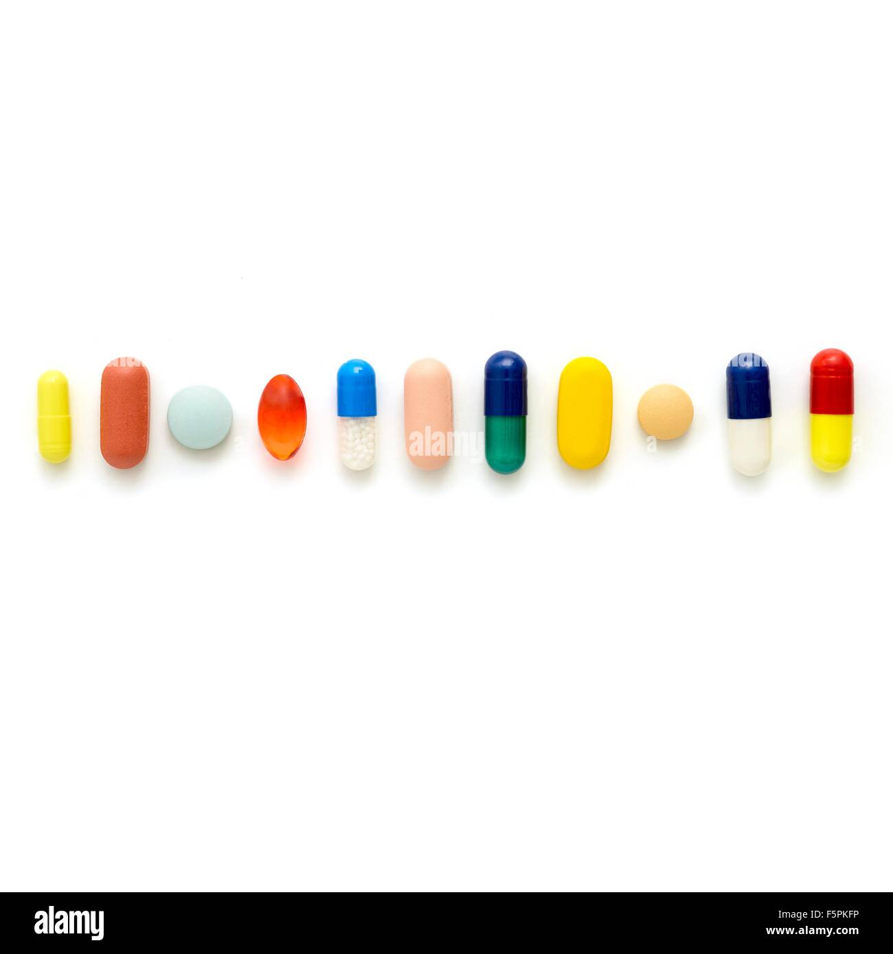 Coloured capsules and tablets against a white background Stock Photo ...