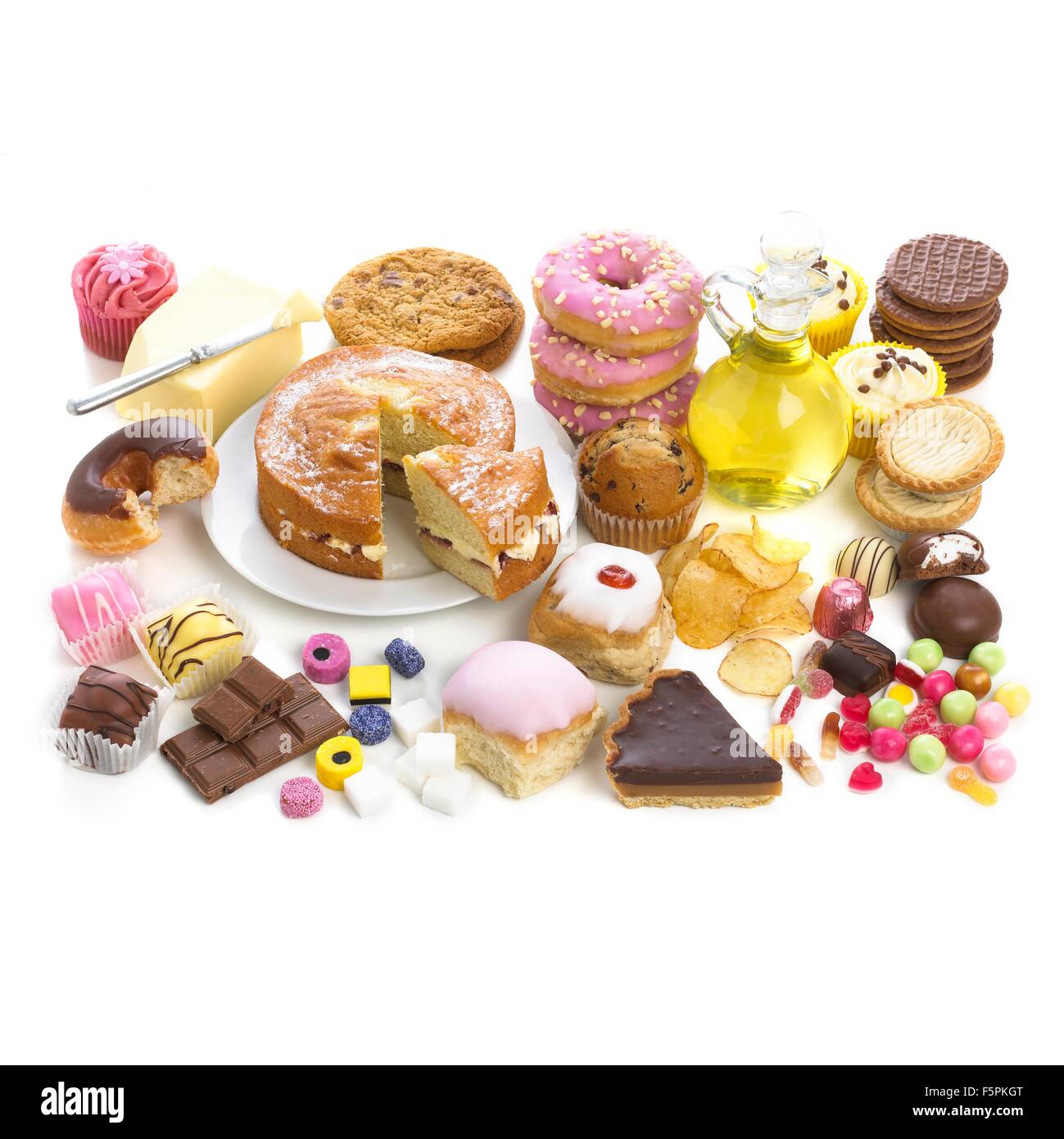 Selection of sweet foods and confectionary against a white background ...