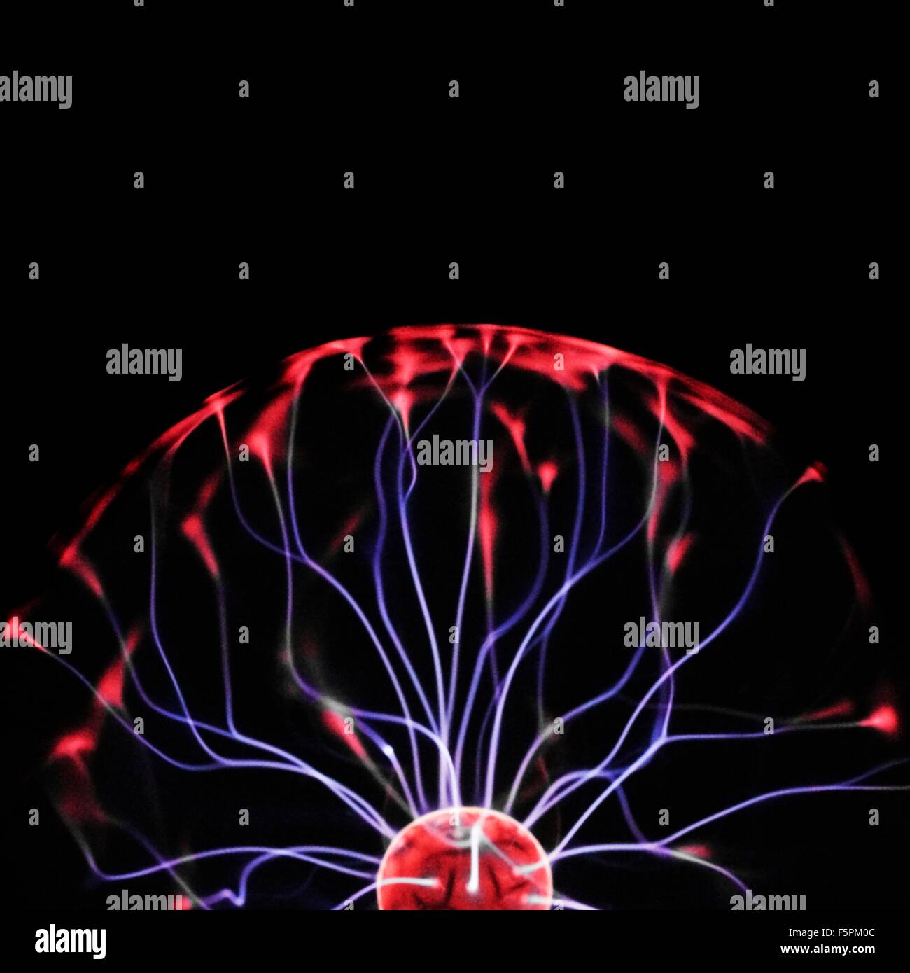 Plasma ball against a black background Stock Photo - Alamy