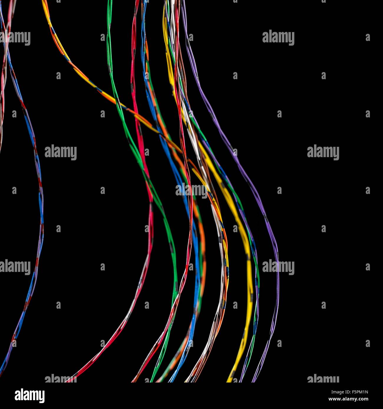 Coloured wires against a black background Stock Photo - Alamy