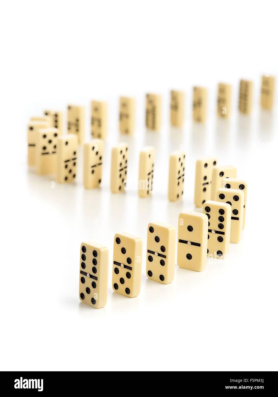 Dominoes in a curved line Stock Photo - Alamy