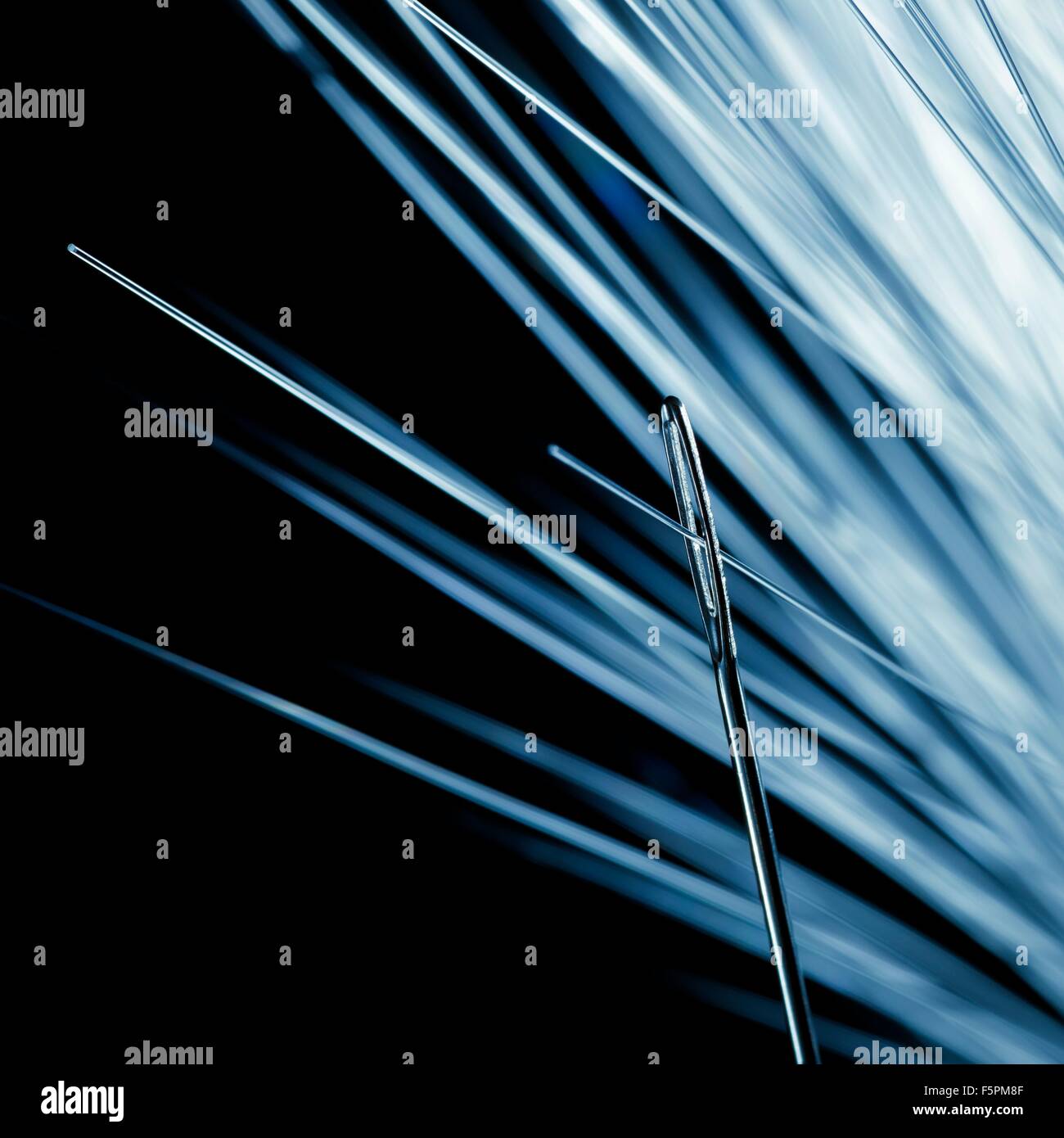 Fibre optic being thread through a needle, close up Stock Photo - Alamy