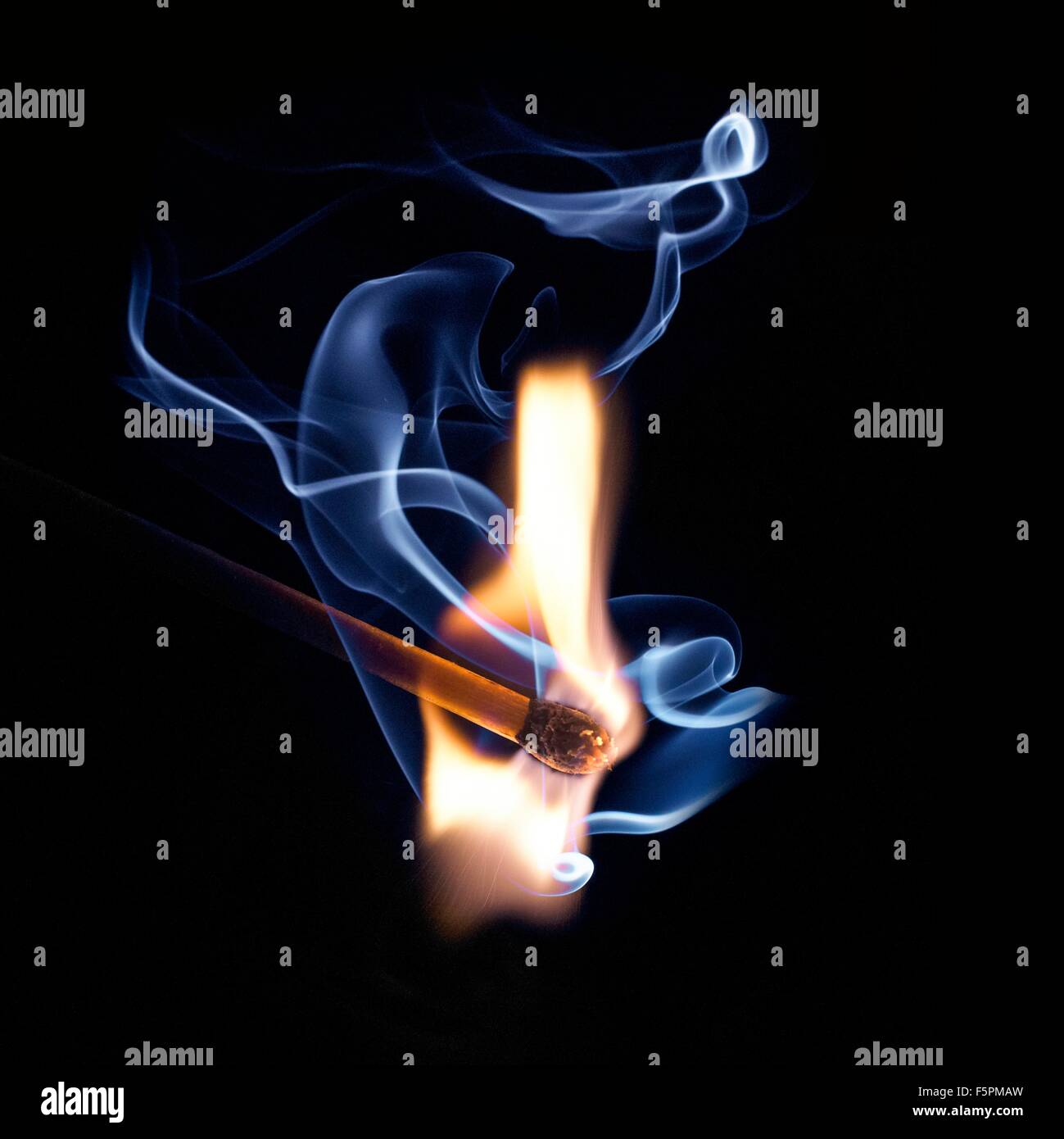 Matchstick on fire against a black background Stock Photo - Alamy