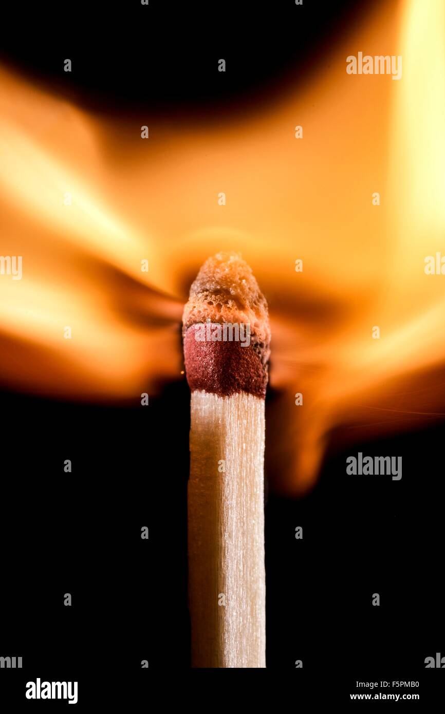 Matchstick on fire against a black background Stock Photo - Alamy