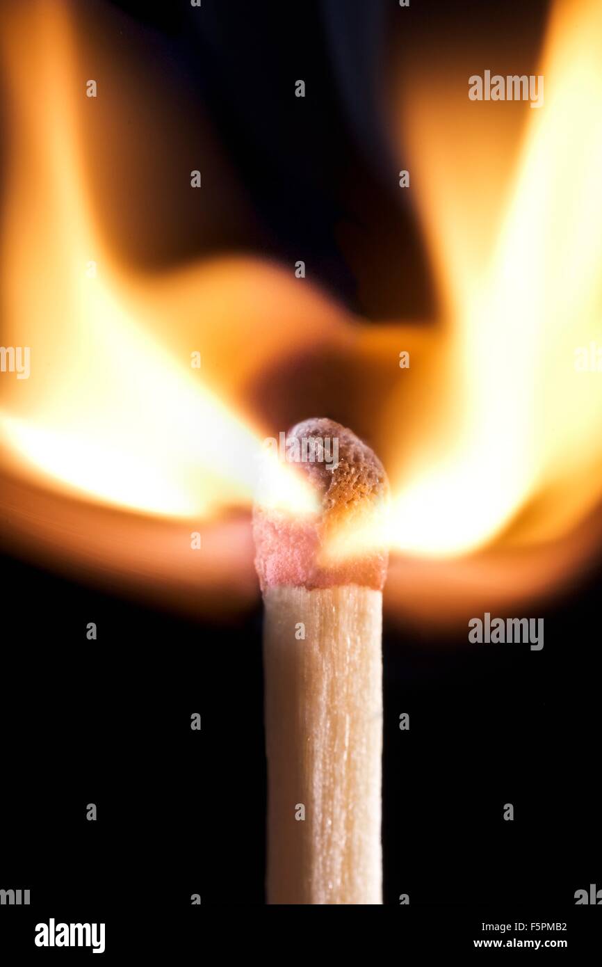 Matchstick on fire against a black background Stock Photo - Alamy