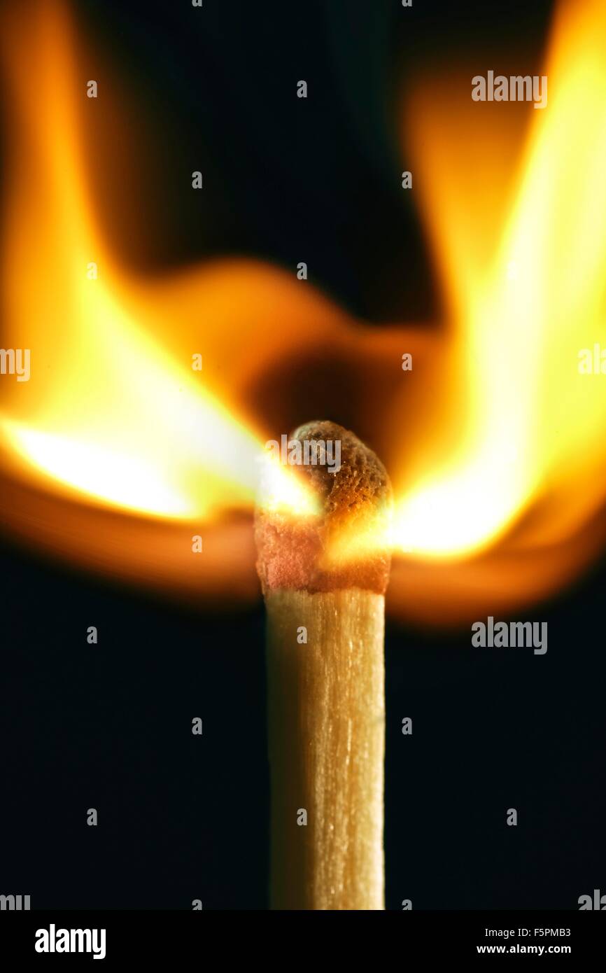 Matchstick on fire against a black background Stock Photo - Alamy