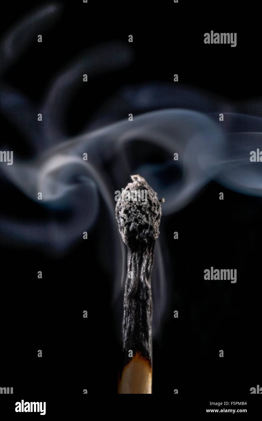 Burnt matchstick and smoke against a black background Stock Photo - Alamy
