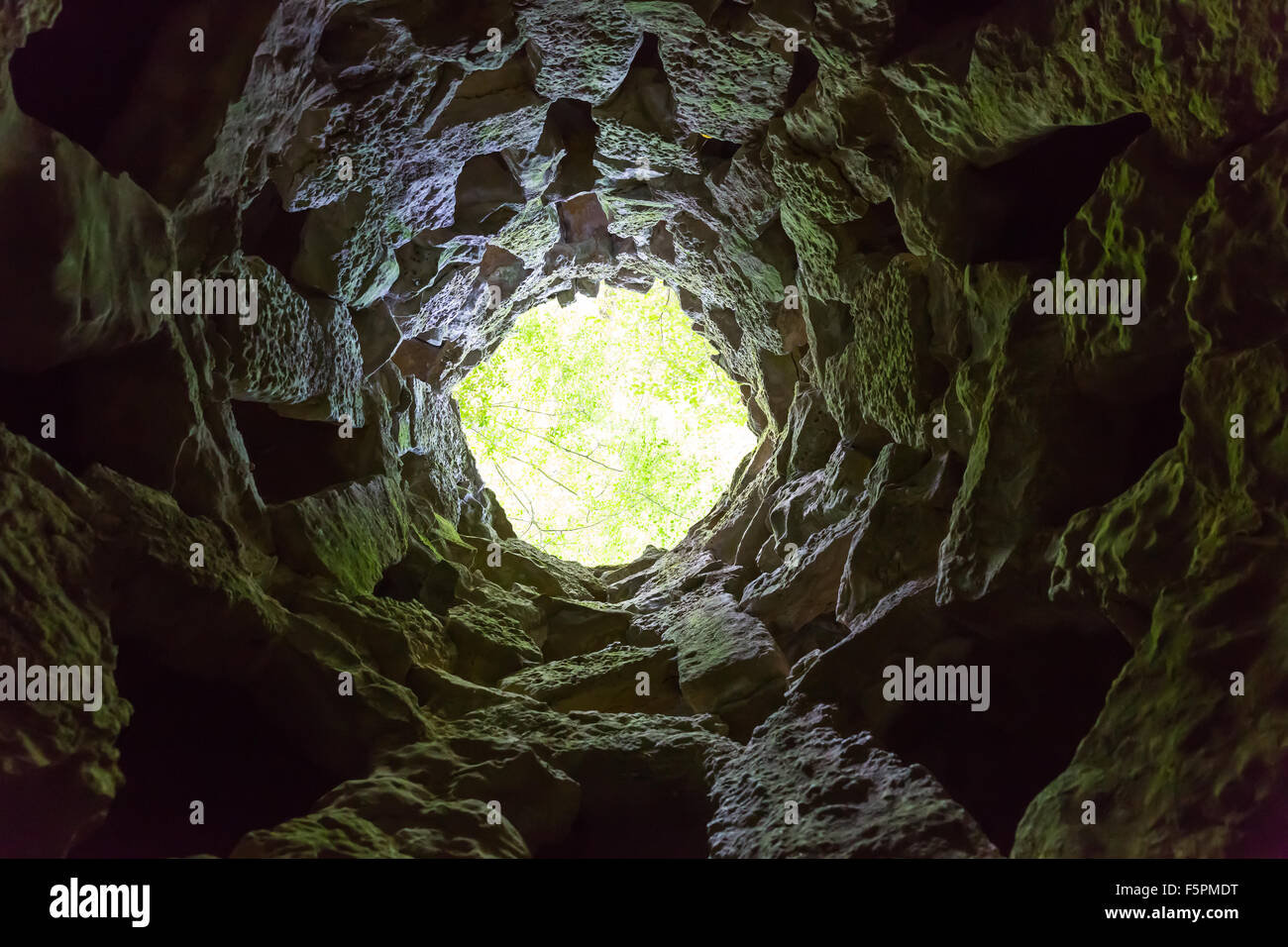 Bottom view from the round narrow cave Stock Photo - Alamy