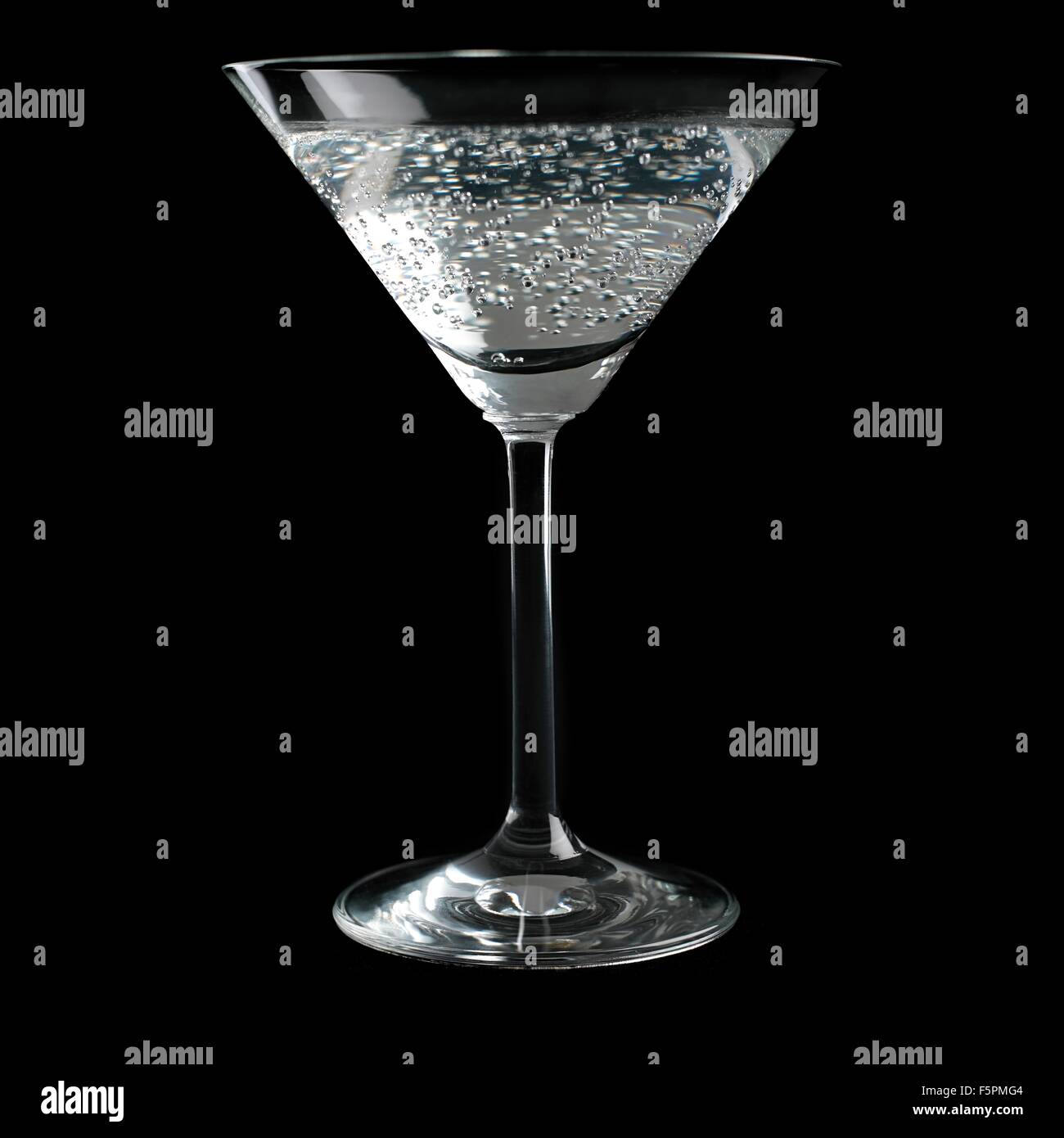Cocktail glass and drink against a black background Stock Photo - Alamy