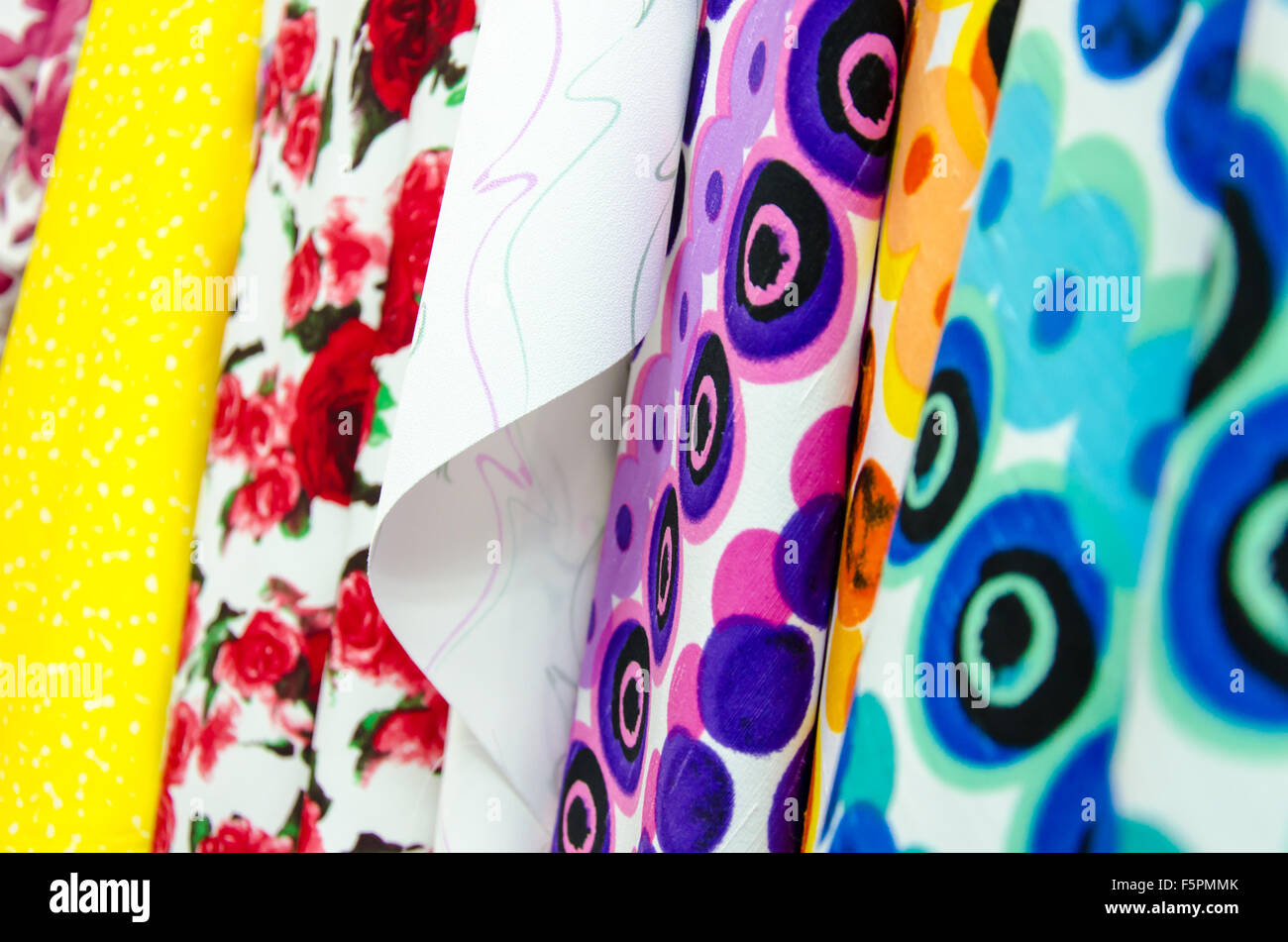 Closeup of various fabric bolts in store Stock Photo - Alamy