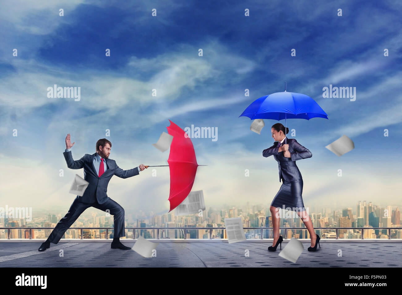 Business people are fighting with umbrellas on the roof Stock Photo - Alamy