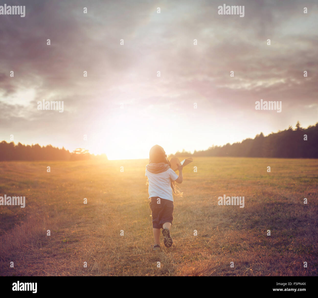 Cute little pilot playing a paper plane Stock Photo - Alamy