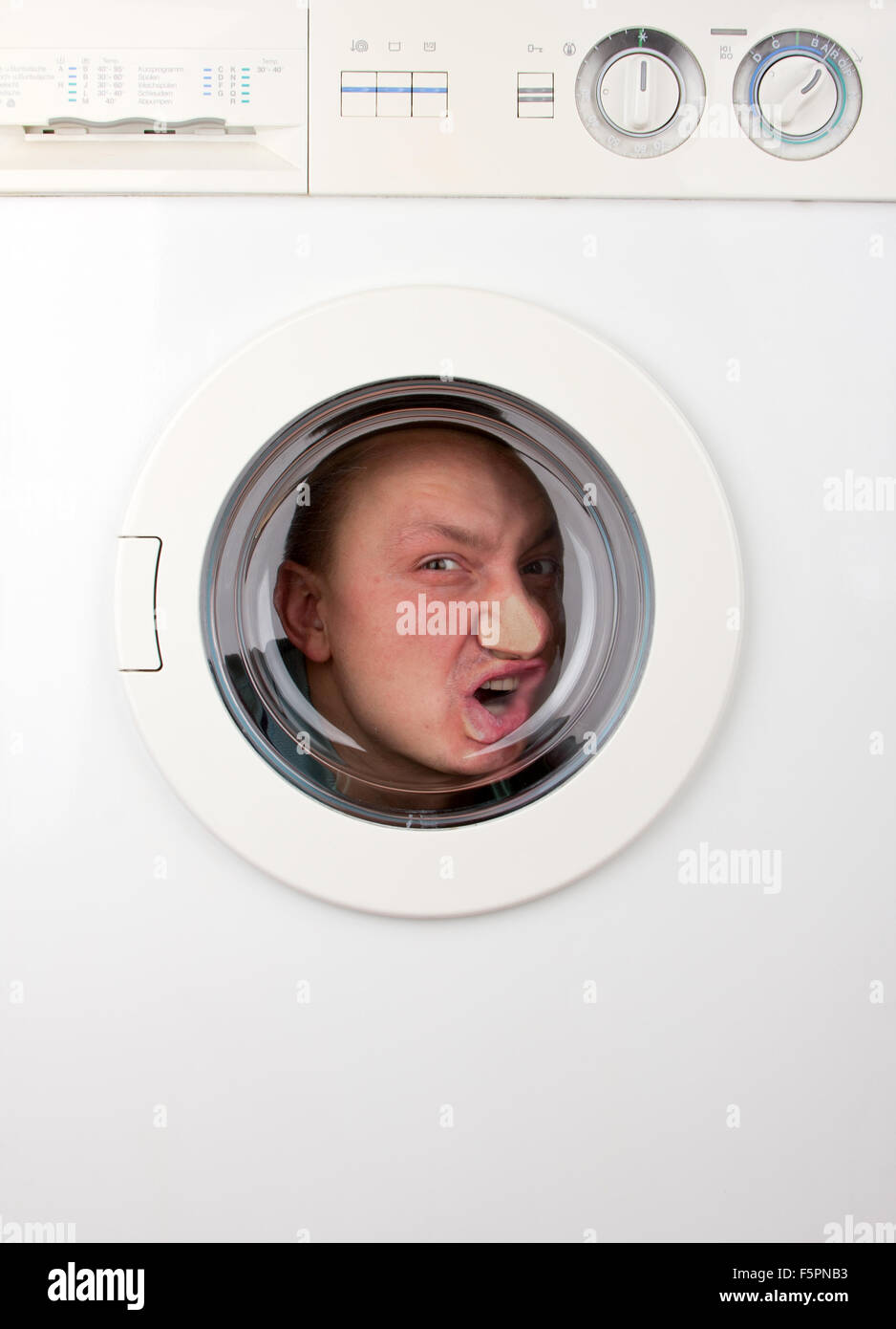 Close-up of bizarre man inside washing machine Stock Photo - Alamy