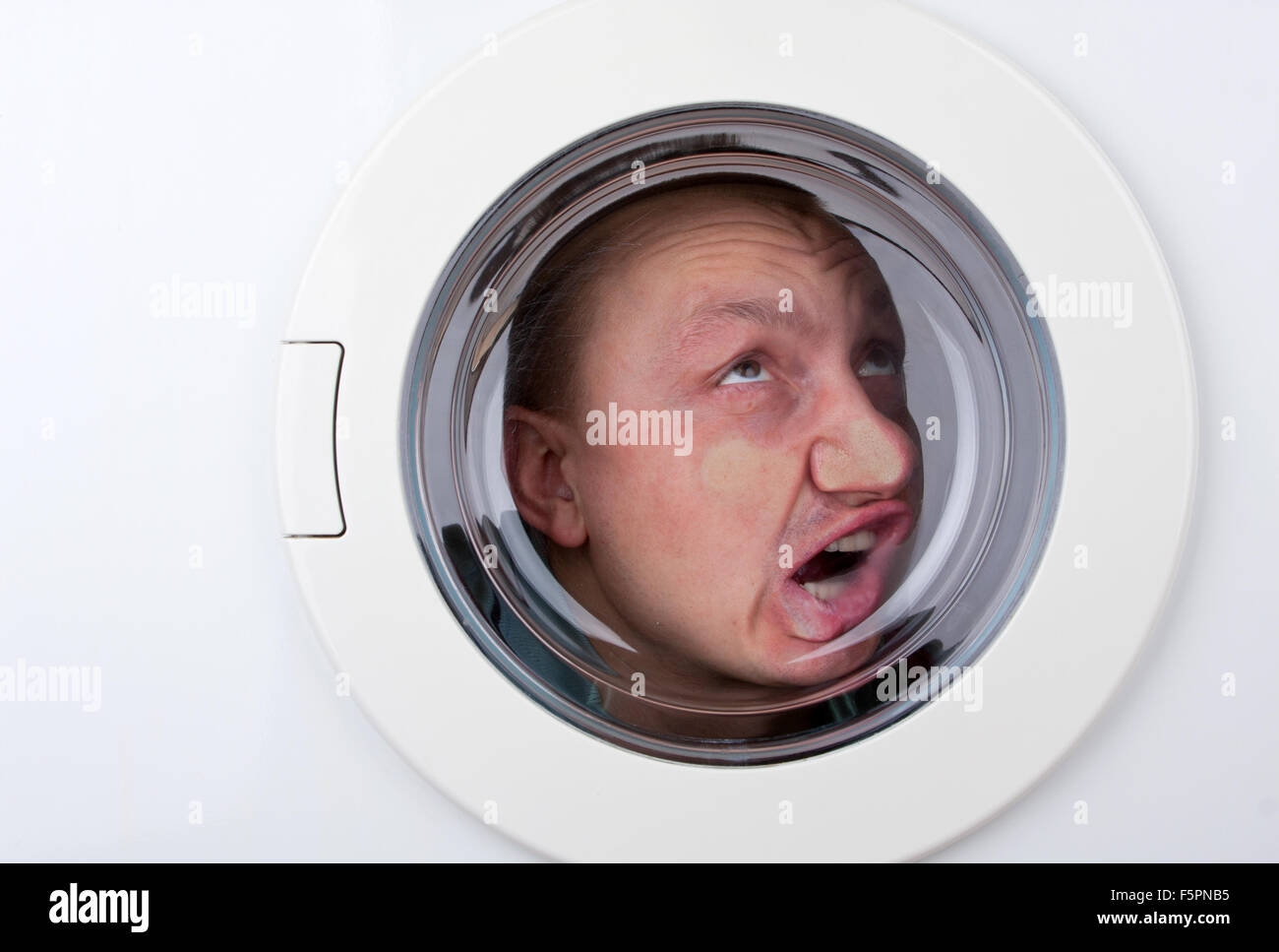 Close-up of bizarre man inside washing machine Stock Photo - Alamy