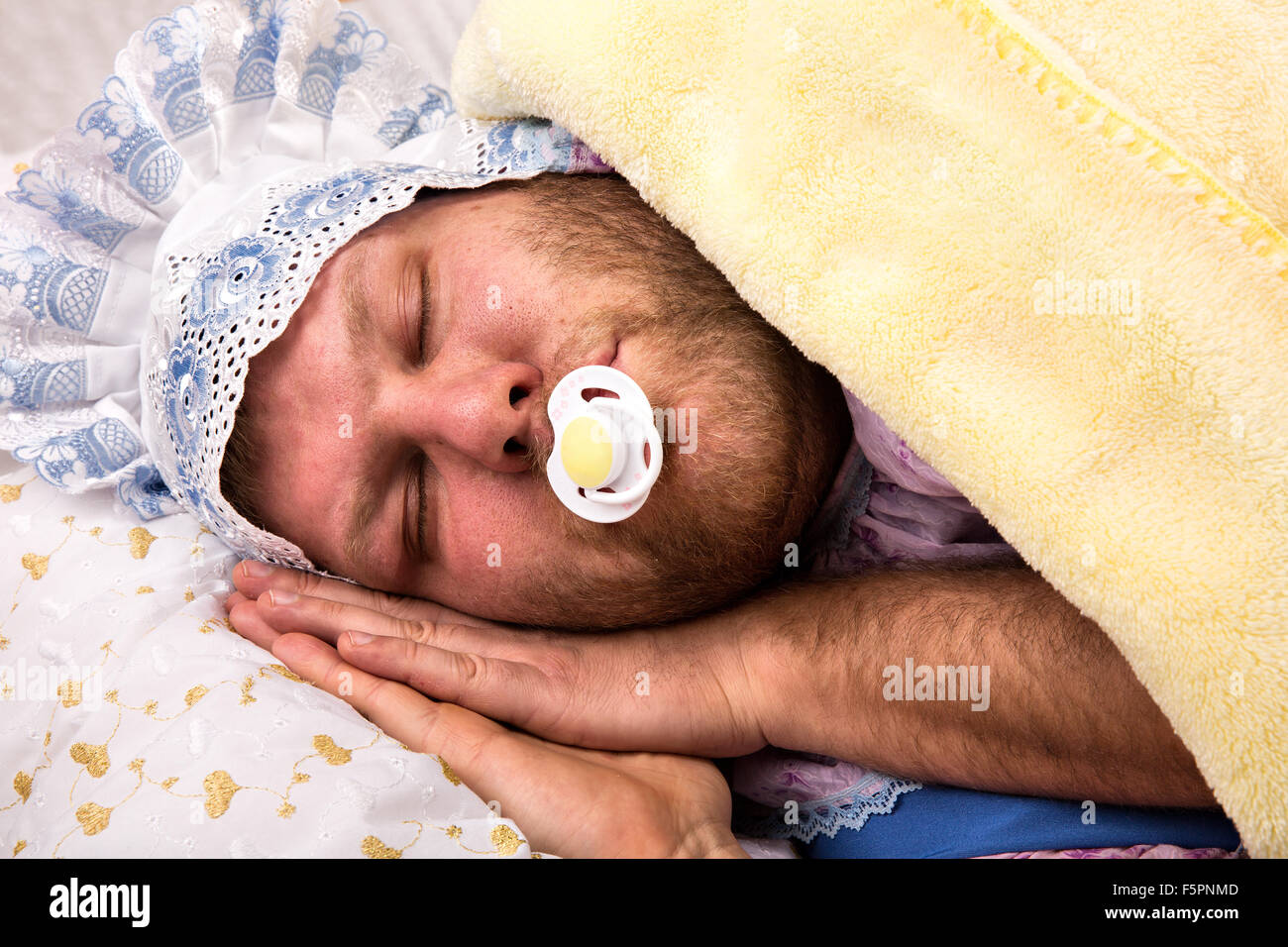 Crazy man weared as baby sleeping Stock Photo - Alamy
