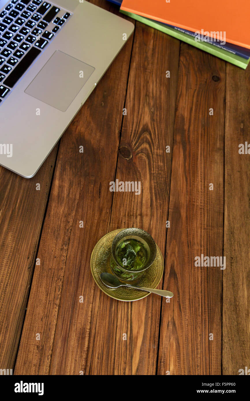 Workplace on wooden desk with tea Stock Photo - Alamy