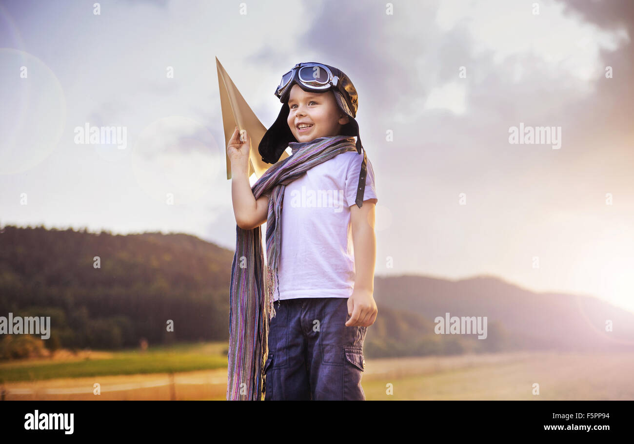 Cute little pilot holding a paper plane Stock Photo - Alamy