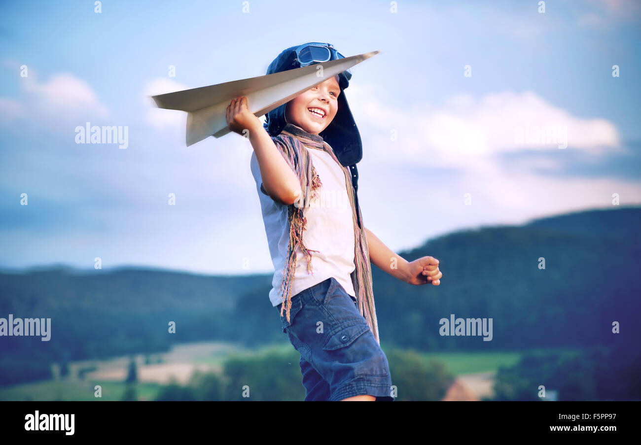 Cheerful little boy toy paper plane Stock Photo - Alamy