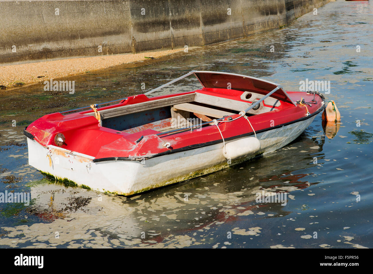 Sad looking speedboat, clearly in need of some TLC. Red and white boat ...