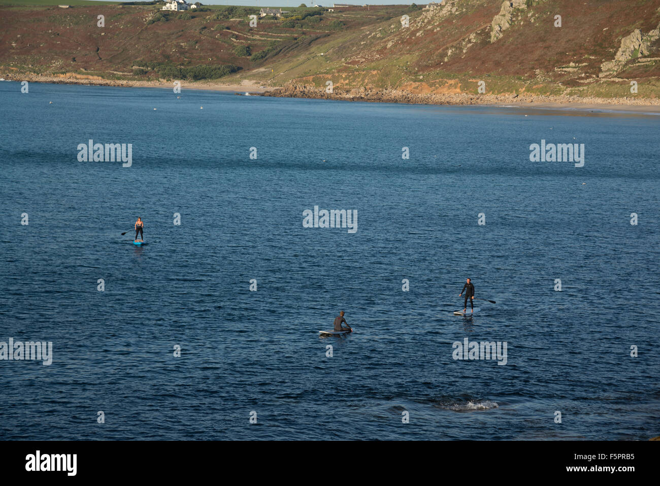 stand up paddleboarders in sennen cove Stock Photo - Alamy