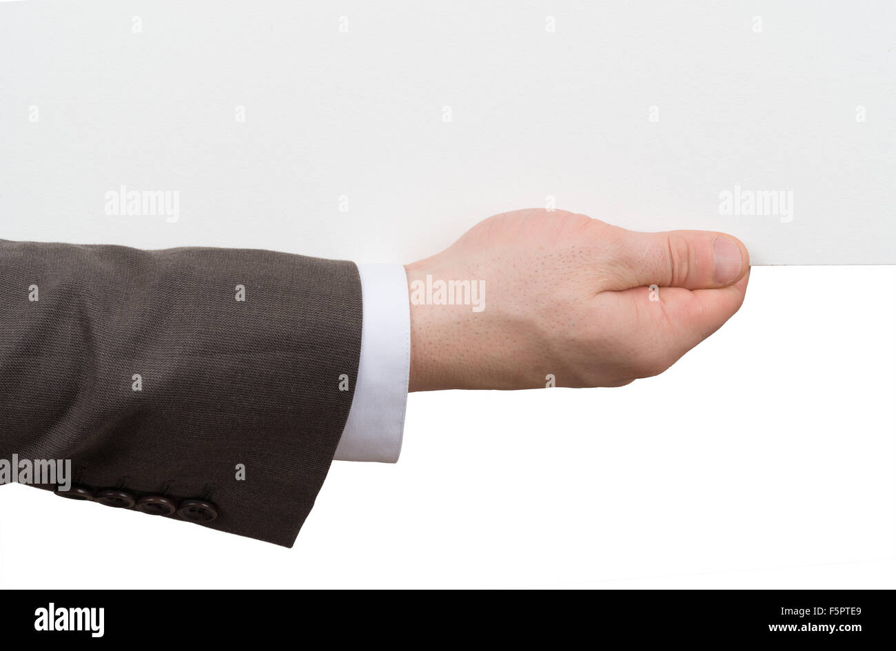 Mans hand holding edge of blank paper Stock Photo - Alamy