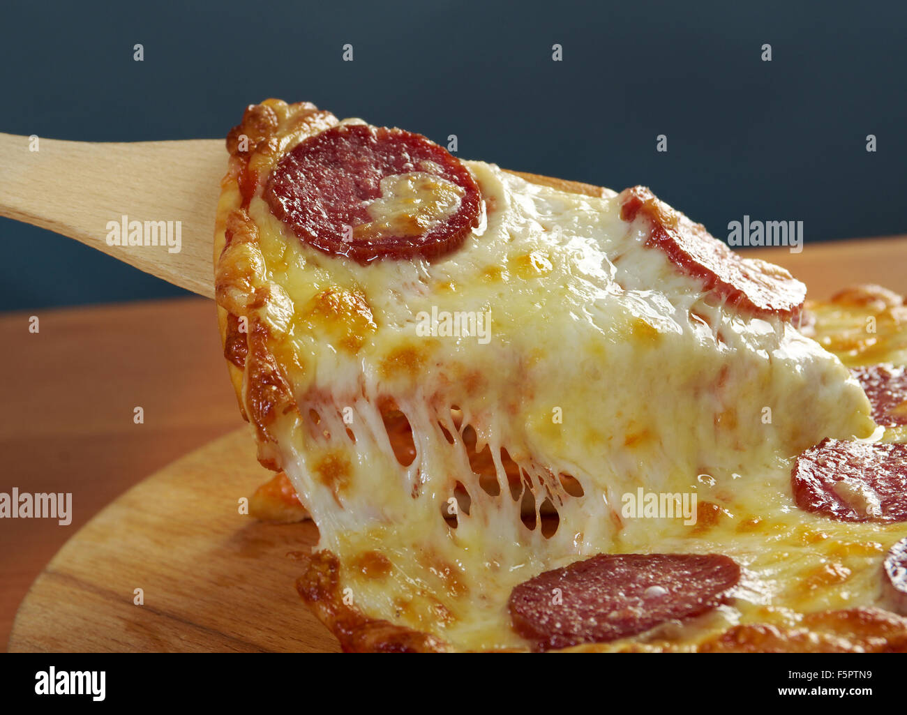 homemade pizza Pepperoni .taking slice of pizza,melted cheese dripping ...