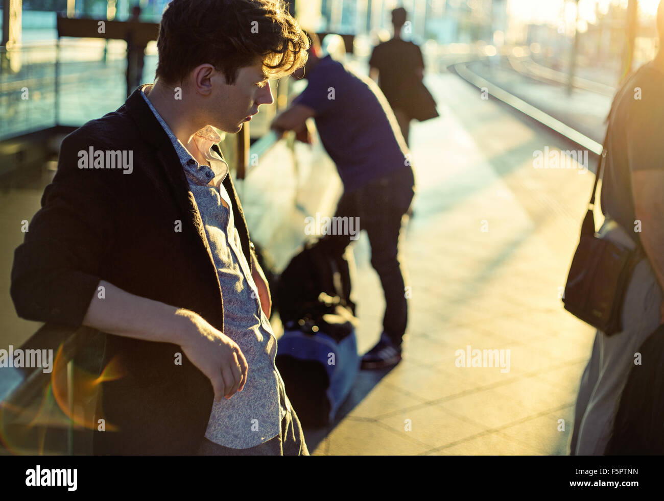 Calm elegant guy waiting for train Stock Photo - Alamy