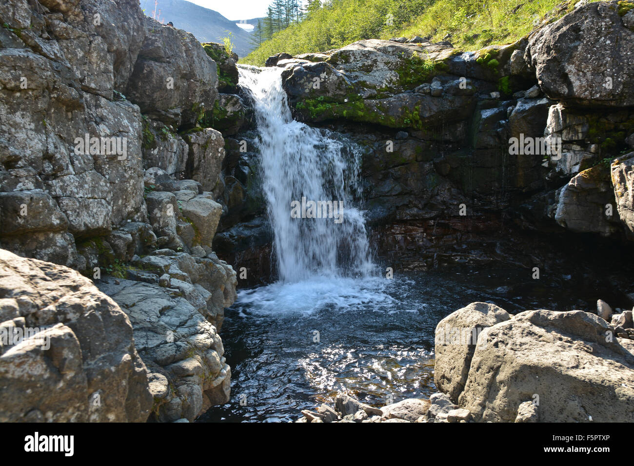 Waterfall on the Putorana plateau. Summer mountain landscape, decorated ...