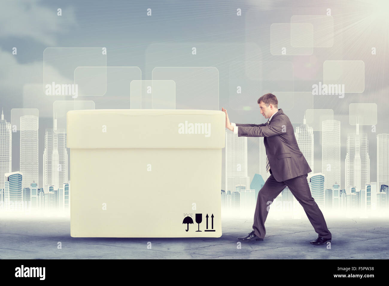 Businessman pushing big white box Stock Photo - Alamy