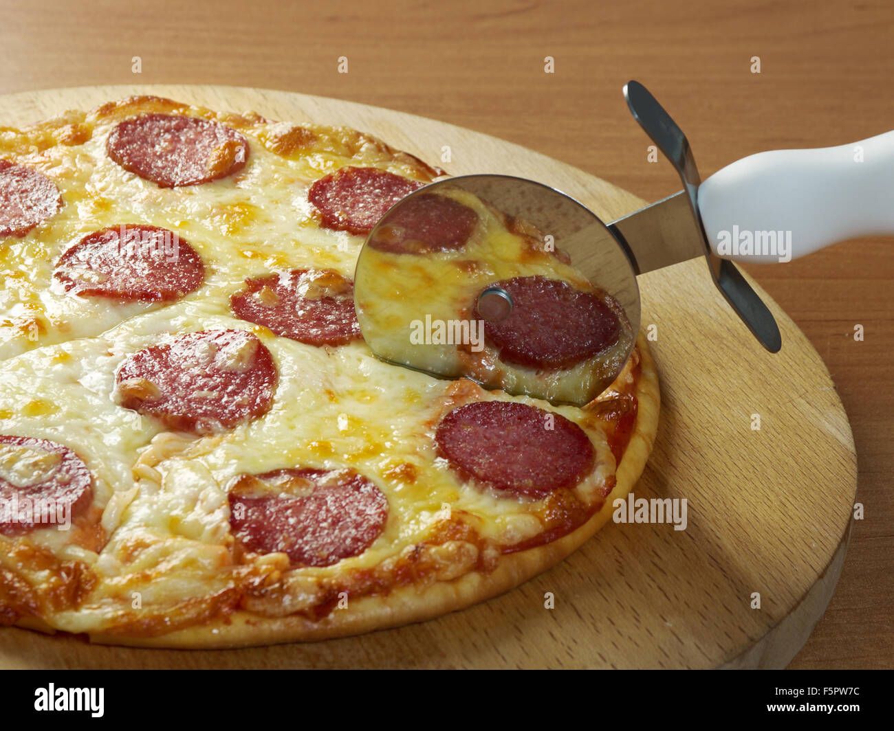 homemade pizza Pepperoni.Closeup a knife cut the pizza Stock Photo - Alamy