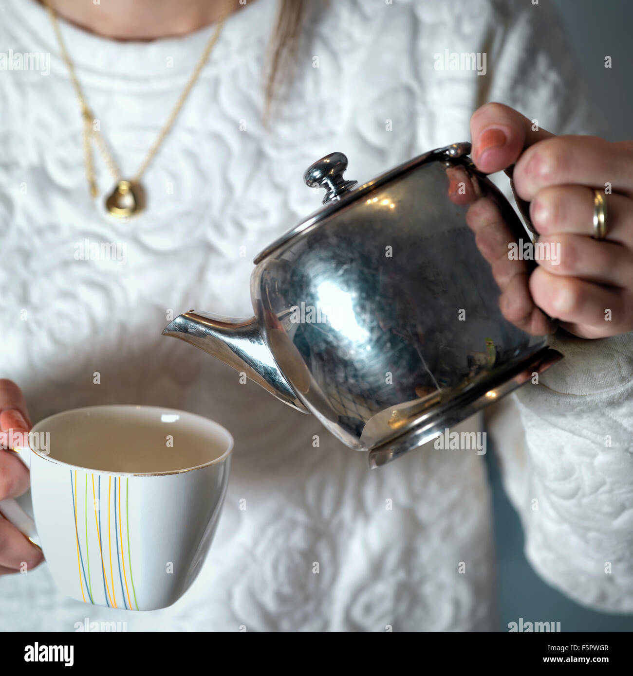 Woman Pouring Tea Stock Photo - Alamy