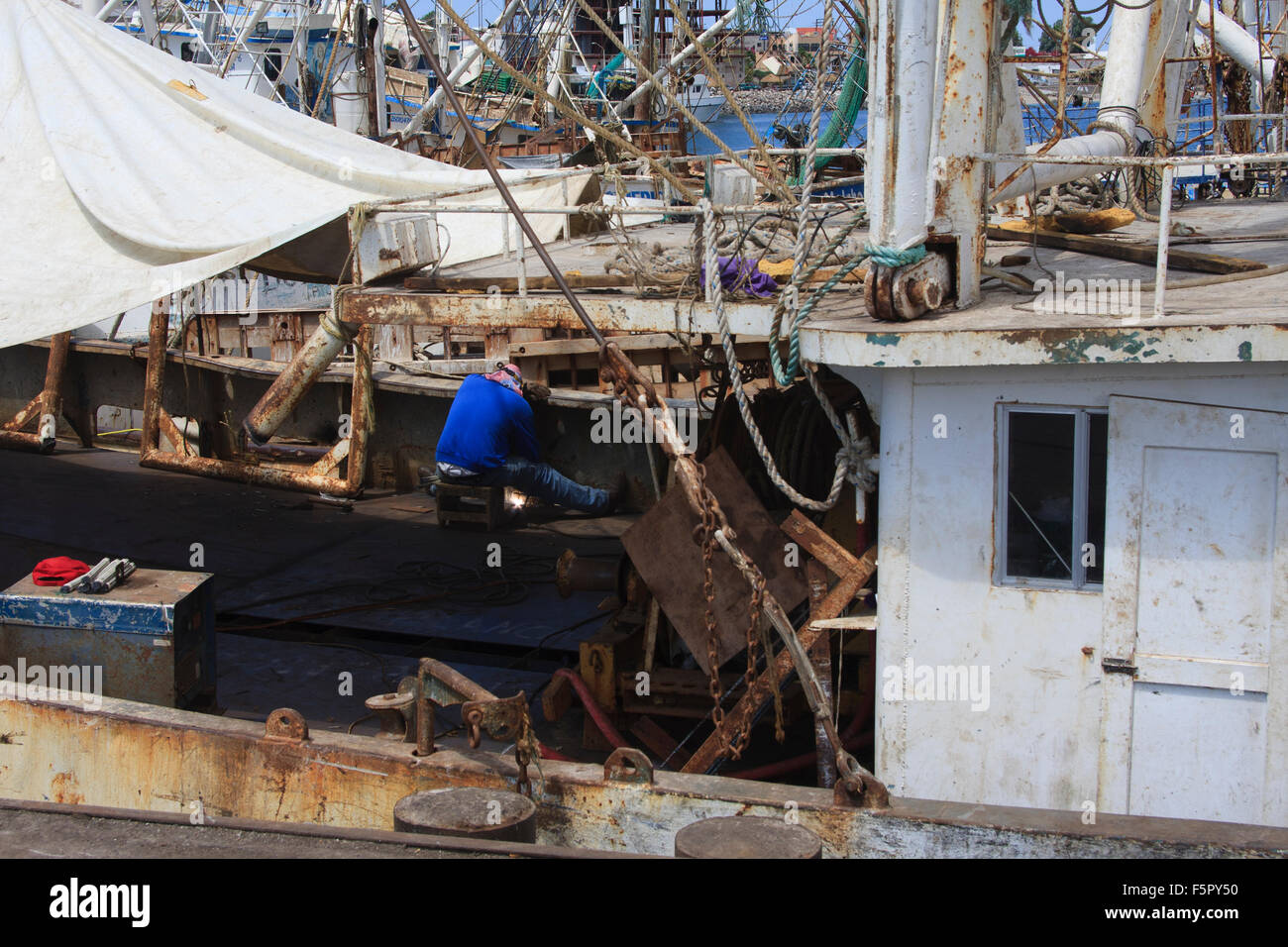Welder repairs fishing vessel Stock Photo - Alamy