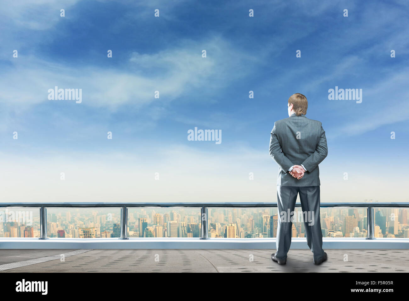 Businessman stands on top skyscraper hi-res stock photography and ...