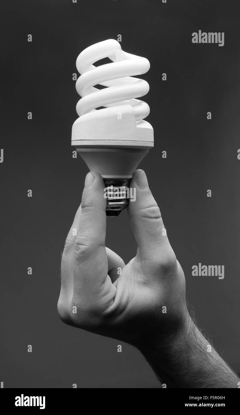 Man hand holding contemporary electrical spiral lamp Stock Photo - Alamy