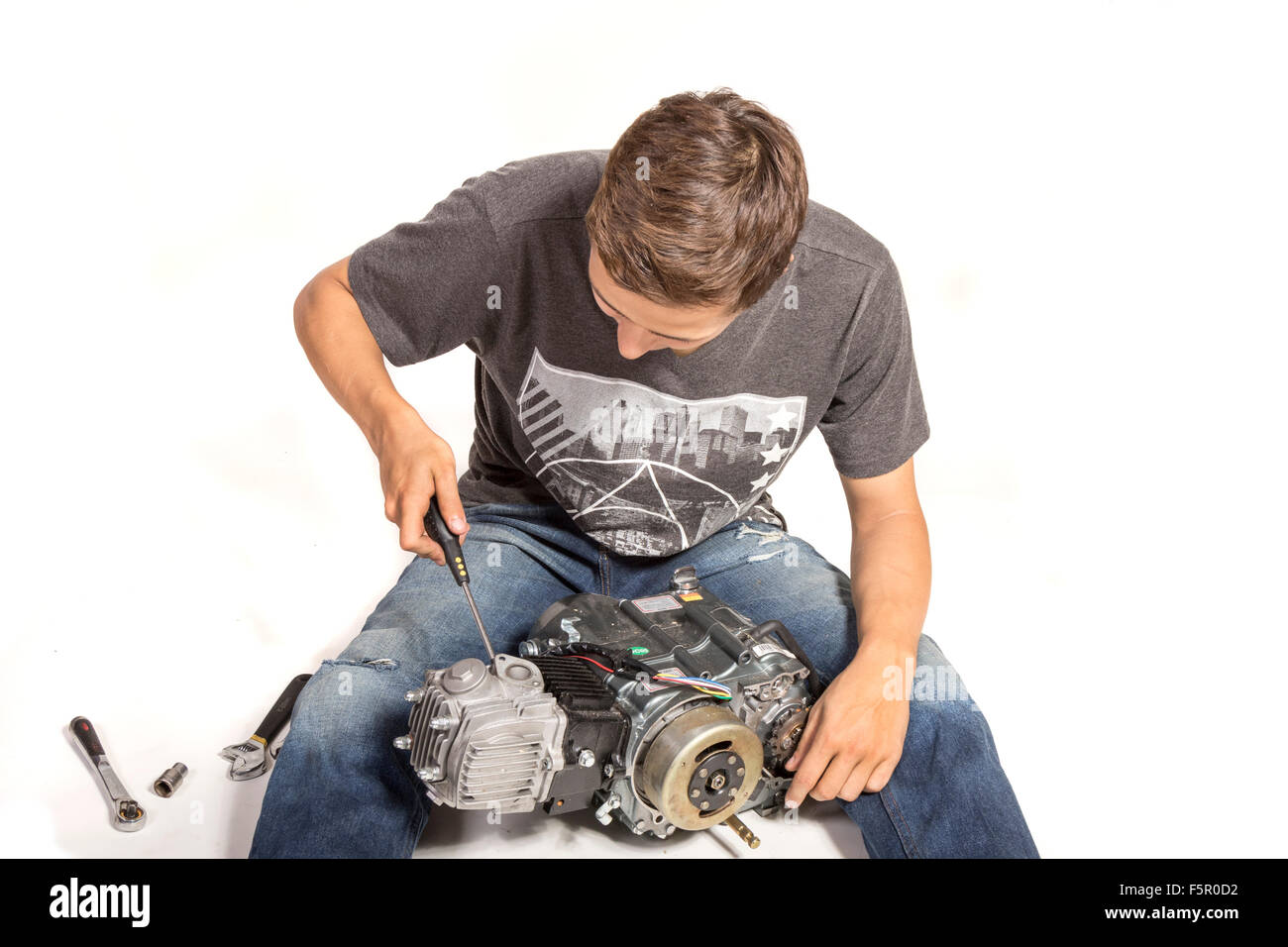 Teenage Boy Fixing an Engine Stock Photo - Alamy
