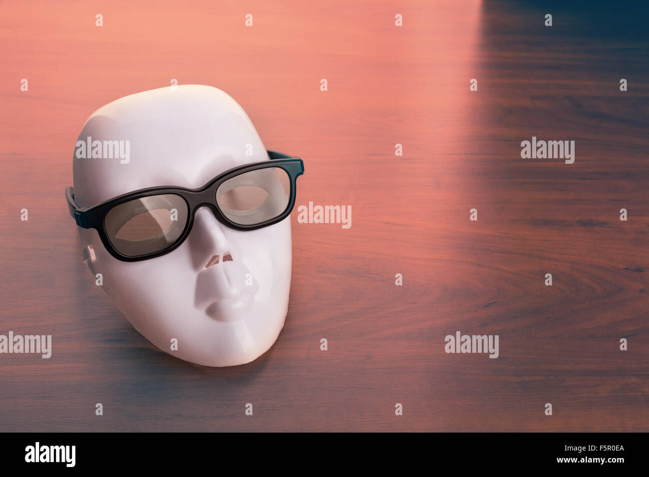 Theater mask in glasses on the wooden table. Toned Stock Photo - Alamy